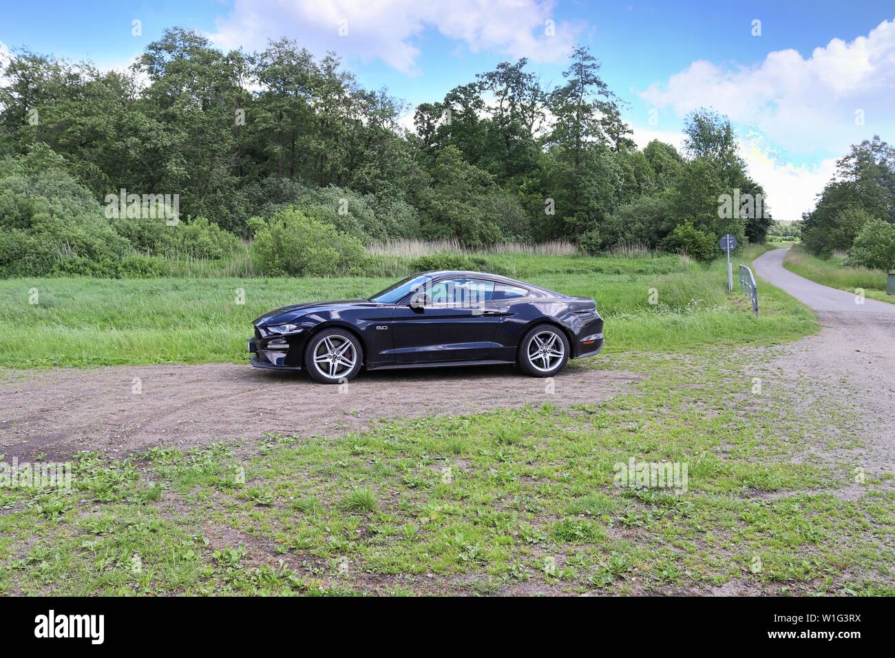 Schleswig-Holstein, Germany - July 02, 2019: Black sports car in front ...