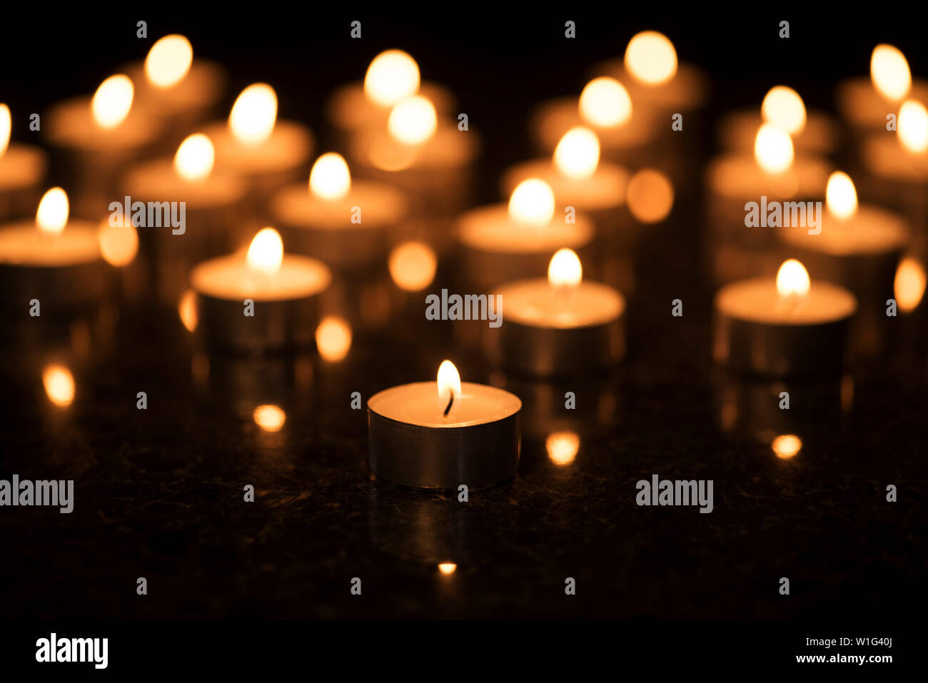 An arrangement of burning tea lights Stock Photo - Alamy