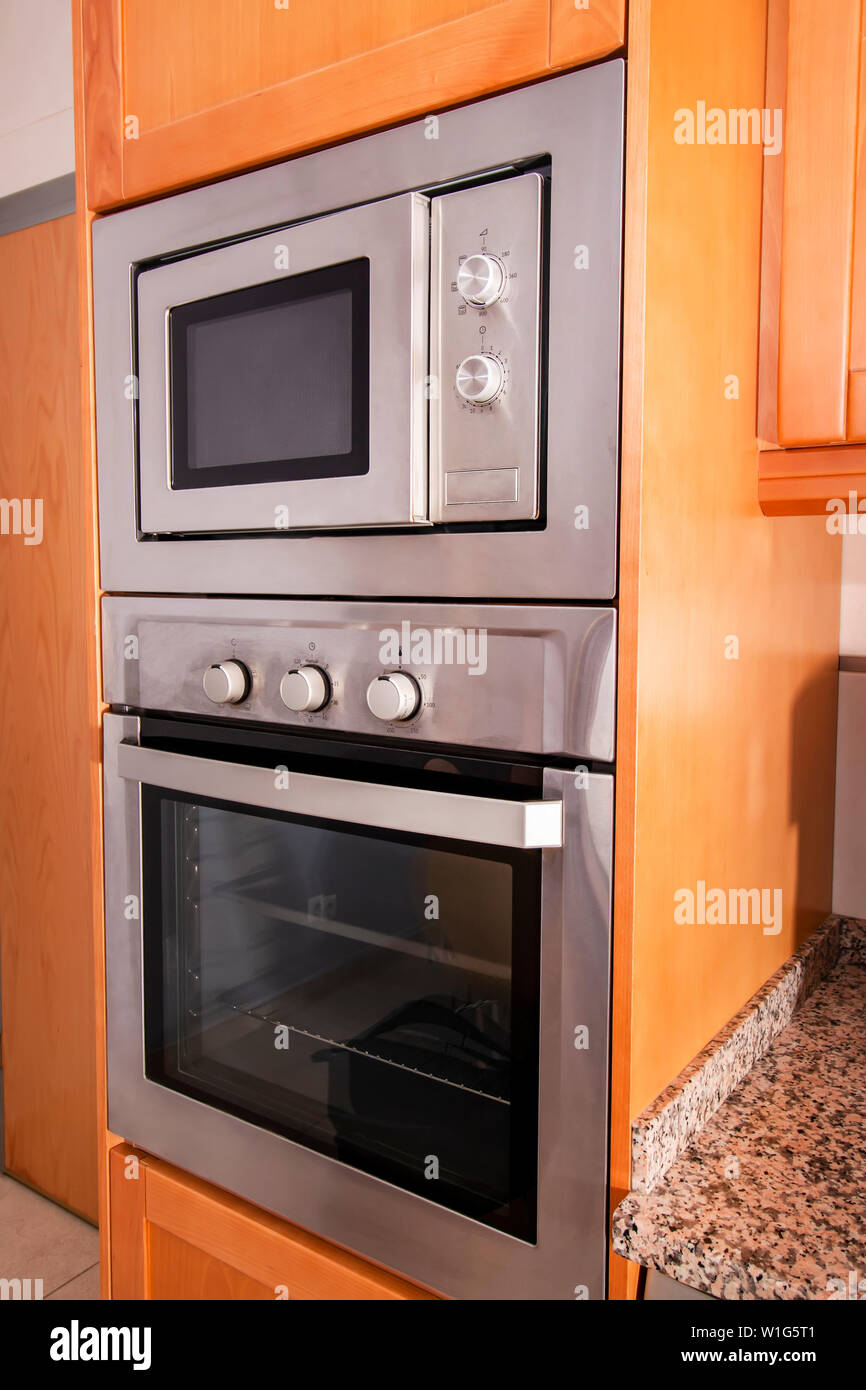 Close up view of a microwave and oven on a kitchen Stock Photo - Alamy