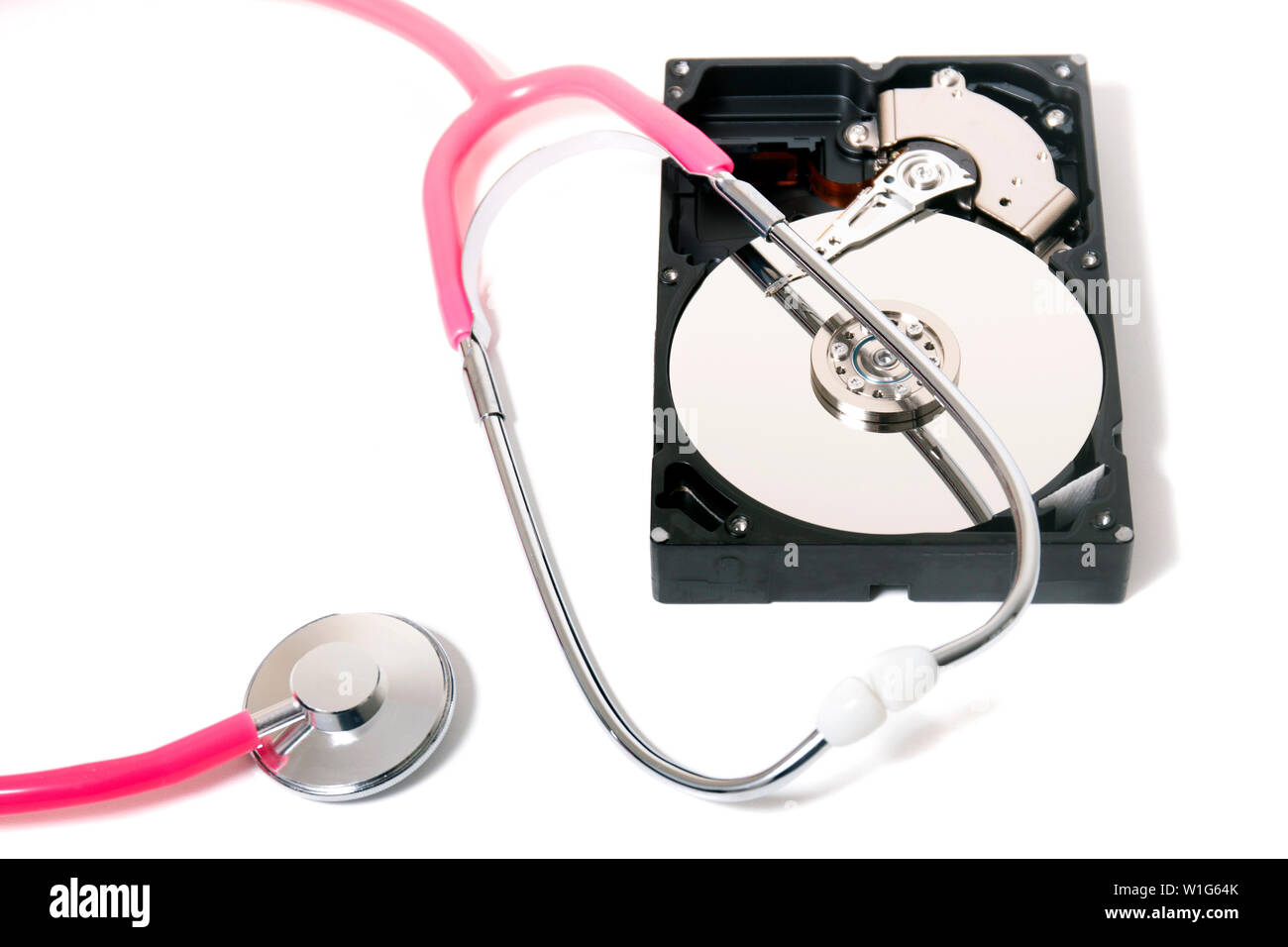 Close up view of a computer hard drive with pink stethoscope concept ...
