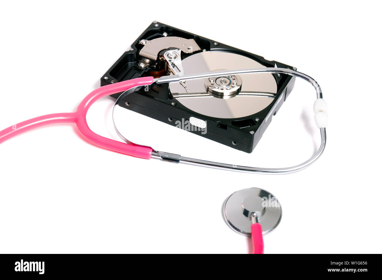 Close up view of a computer hard drive with pink stethoscope concept ...