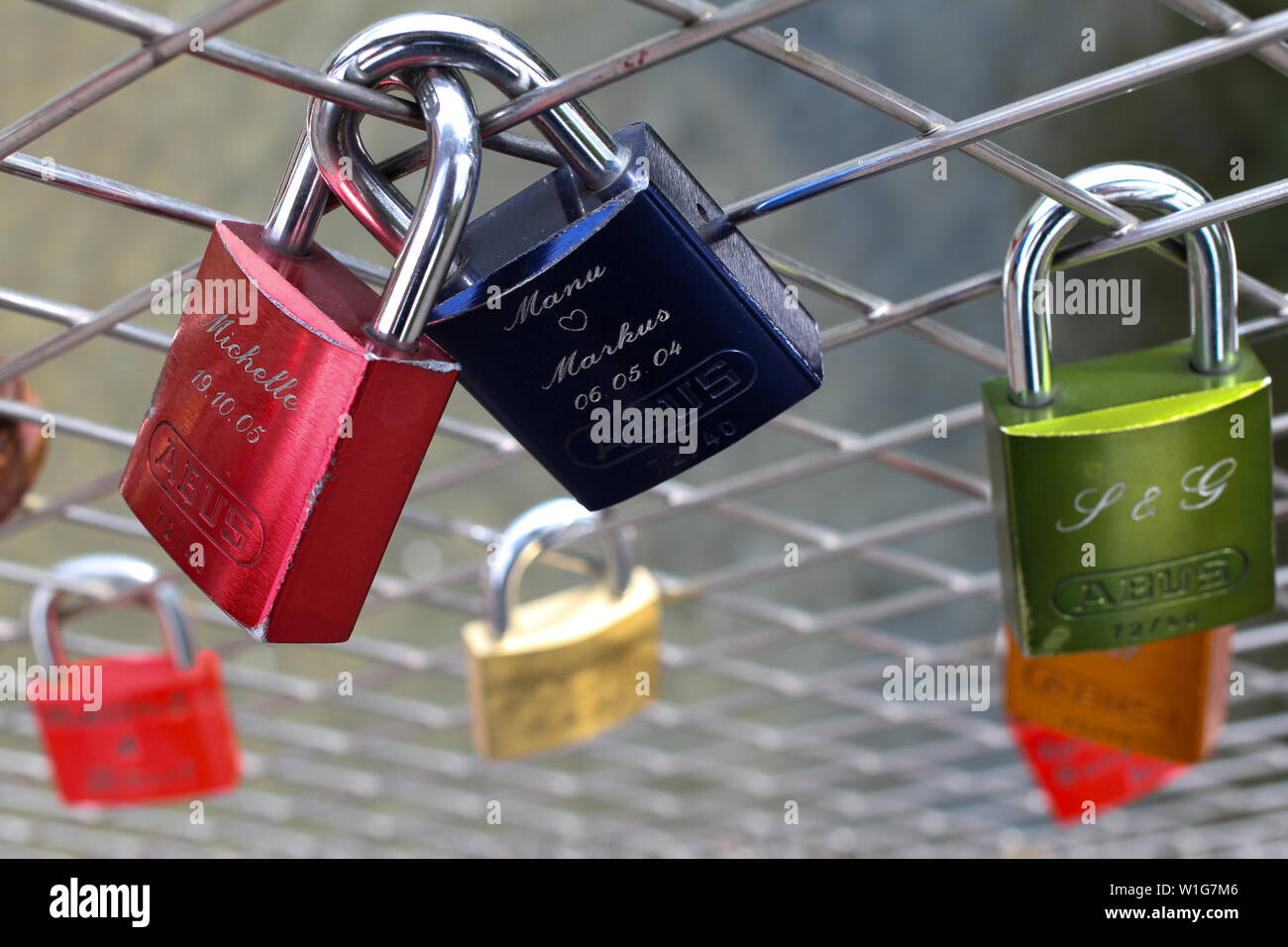 Colourful love locks on grate Stock Photo - Alamy
