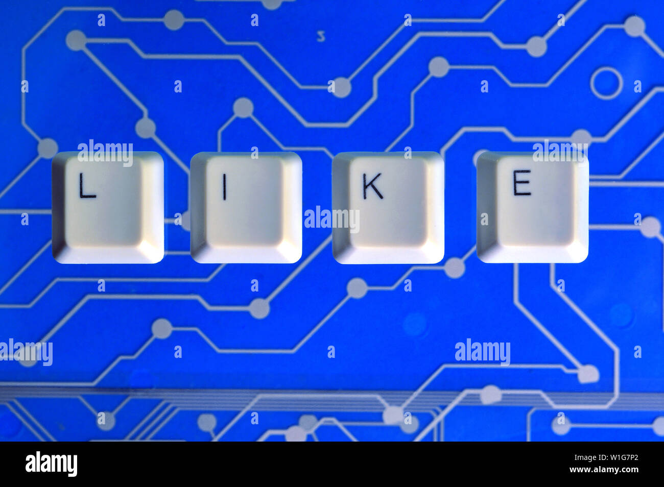Keyboard keys form the word LIKE on blue electric circuit in the ...