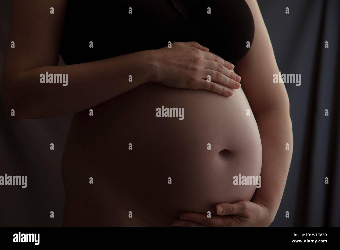 Woman holding baby bump hi-res stock photography and images - Alamy