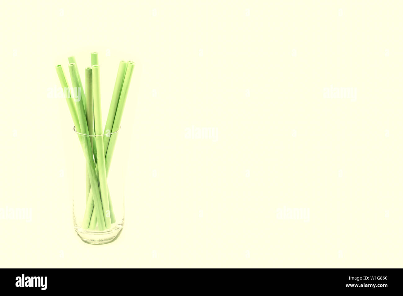 Eco-friendly Bamboo drinking straws against light green background and ...