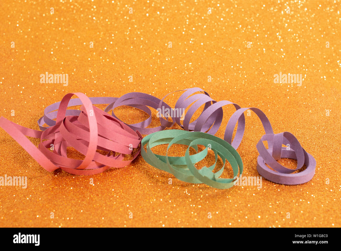 Mixed colorful streamers on a golden background Stock Photo - Alamy