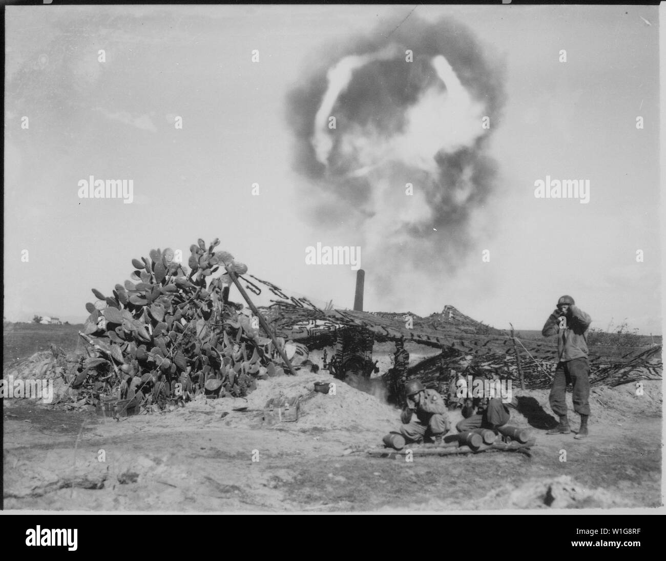 Long Tom speaks. A 155mm gun (Long Tom) is fired by american troops ...