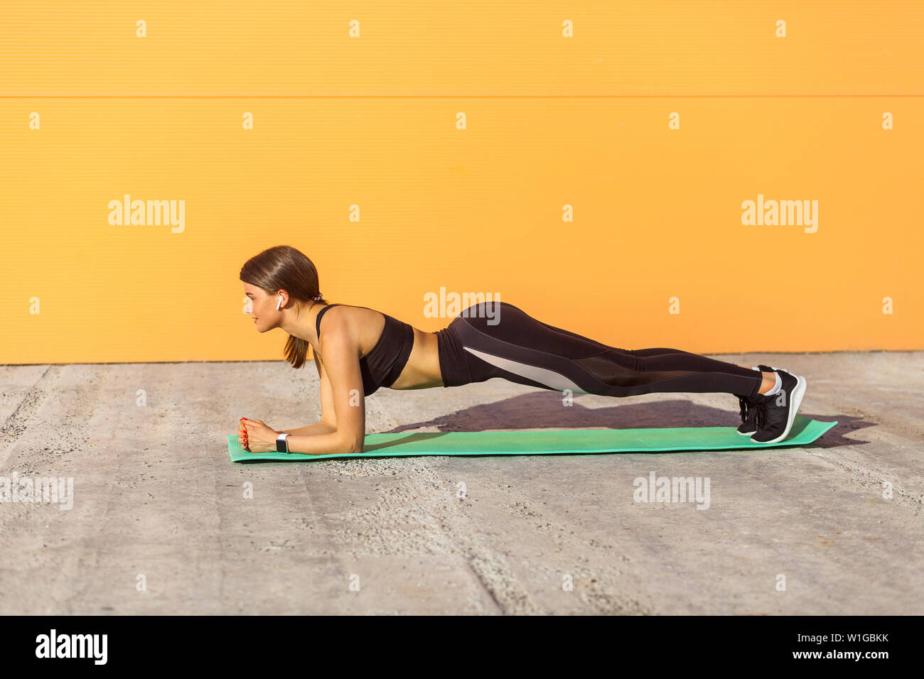 Side view portrait of muscular sporty strong young athletic woman in ...