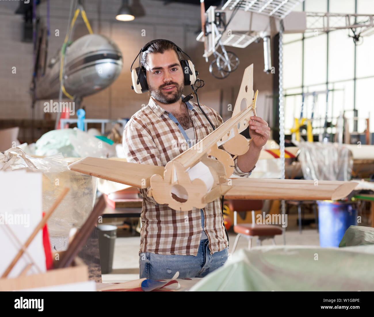 Smiling young man in pilot aviation headsets having fun with light ...