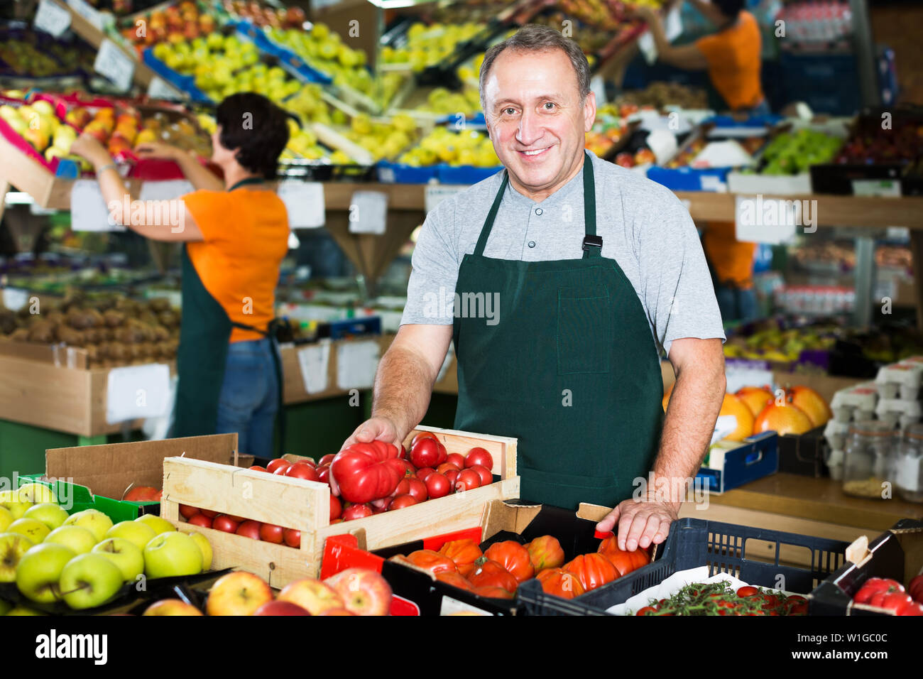 Adult seller offering red hi-res stock photography and images - Alamy