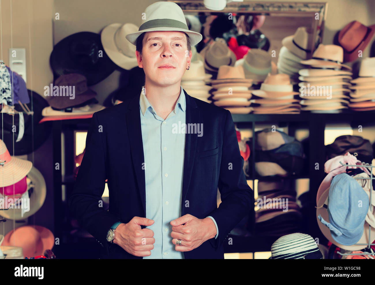 Portrait of adult male try on hat at the shopping mall Stock Photo - Alamy