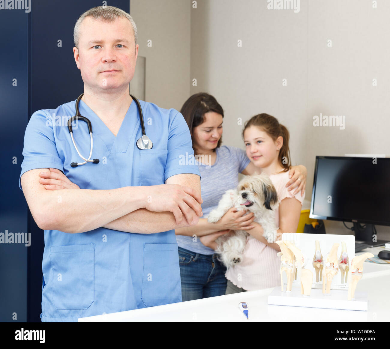 Portrait of professional man veterinarian posing at modern vet clinic ...