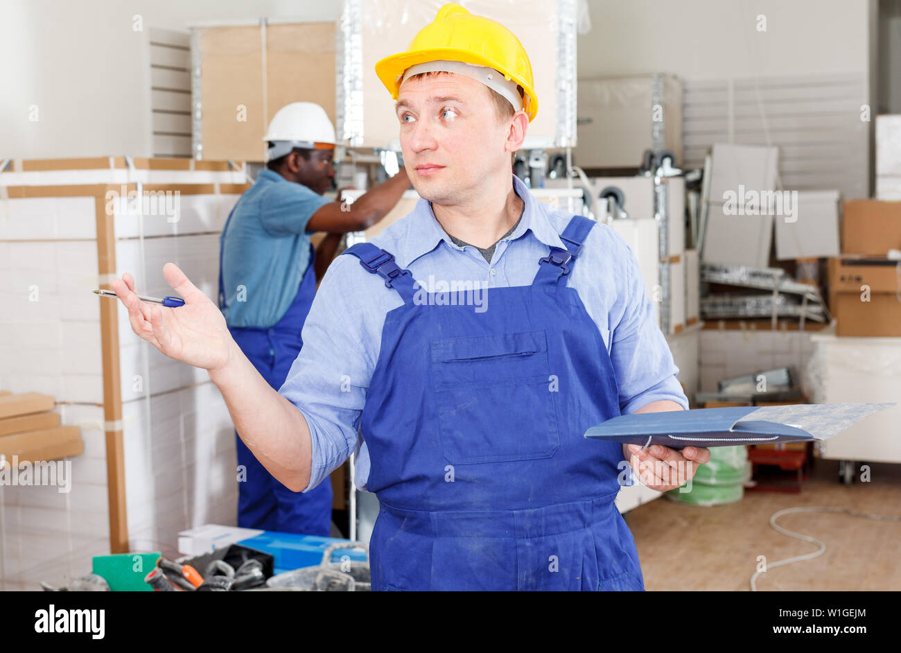 Confident builder handyman examining room and planning construction ...