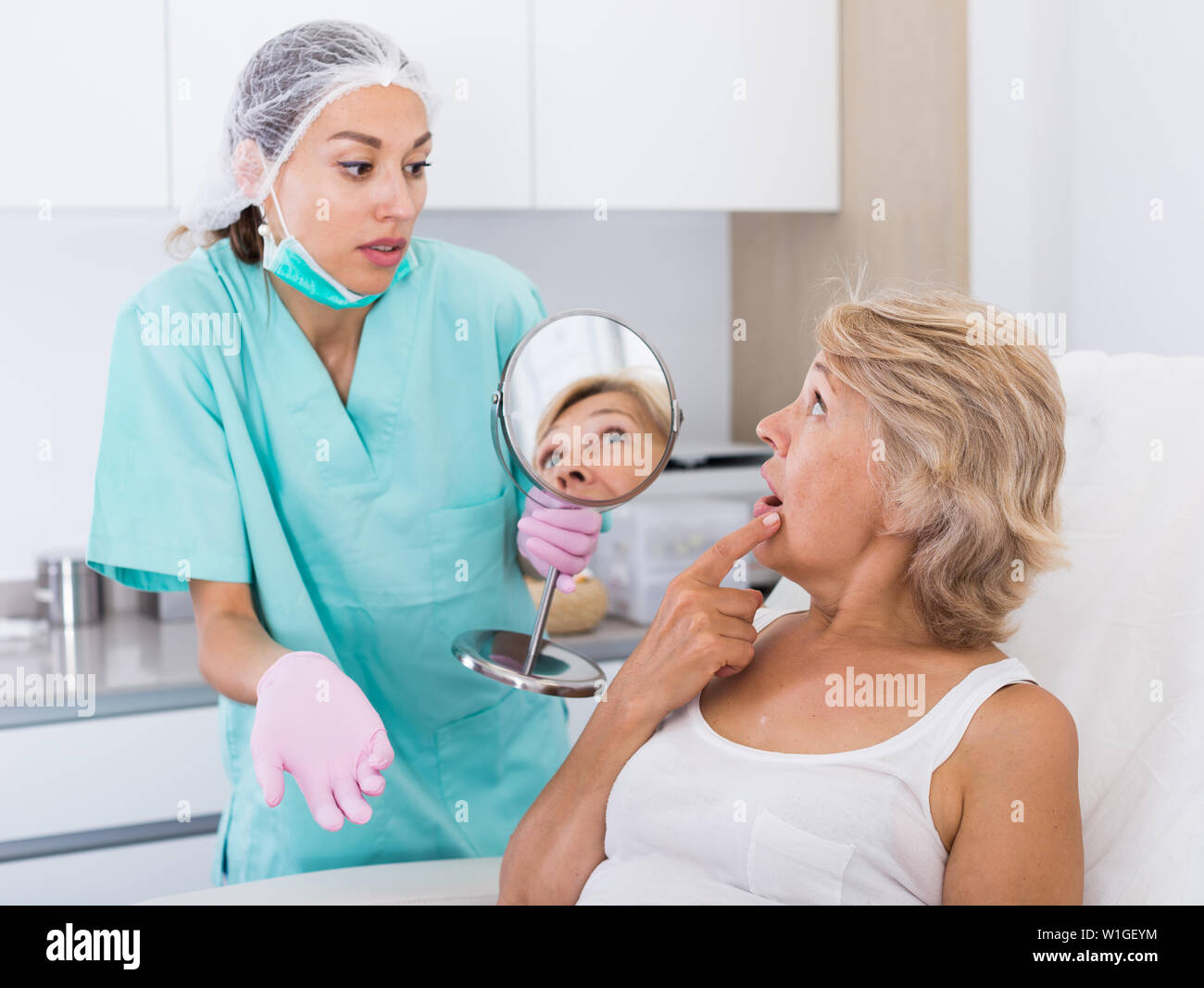 Portrait of unhappy worried woman visiting clinic of esthetic medicine ...