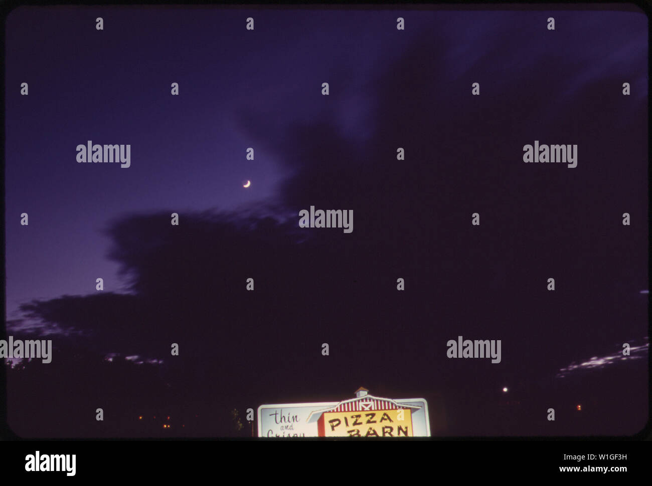 MOON RISES OVER PIZZA SIGN Stock Photo - Alamy