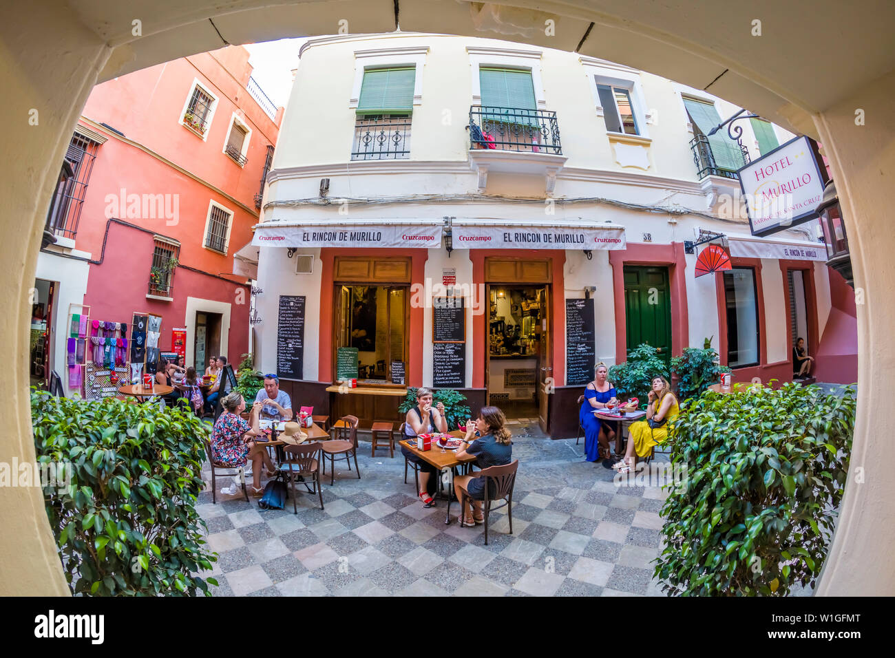 Fisheye view of people at outdoor cafe in the Barrio de Santa Cruz or ...