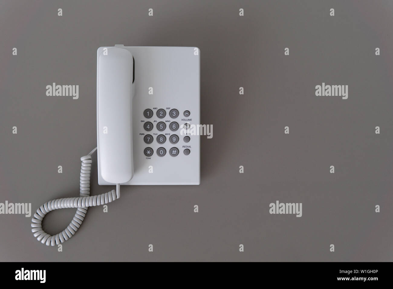 Closeup white phone , office phone on the desk Stock Photo - Alamy