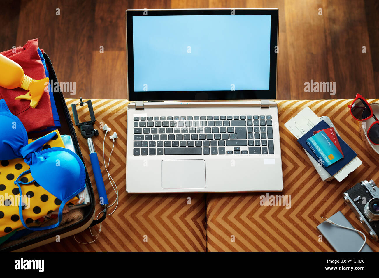 Closeup on laptop with blank screen and travel stuff while sitting on ...