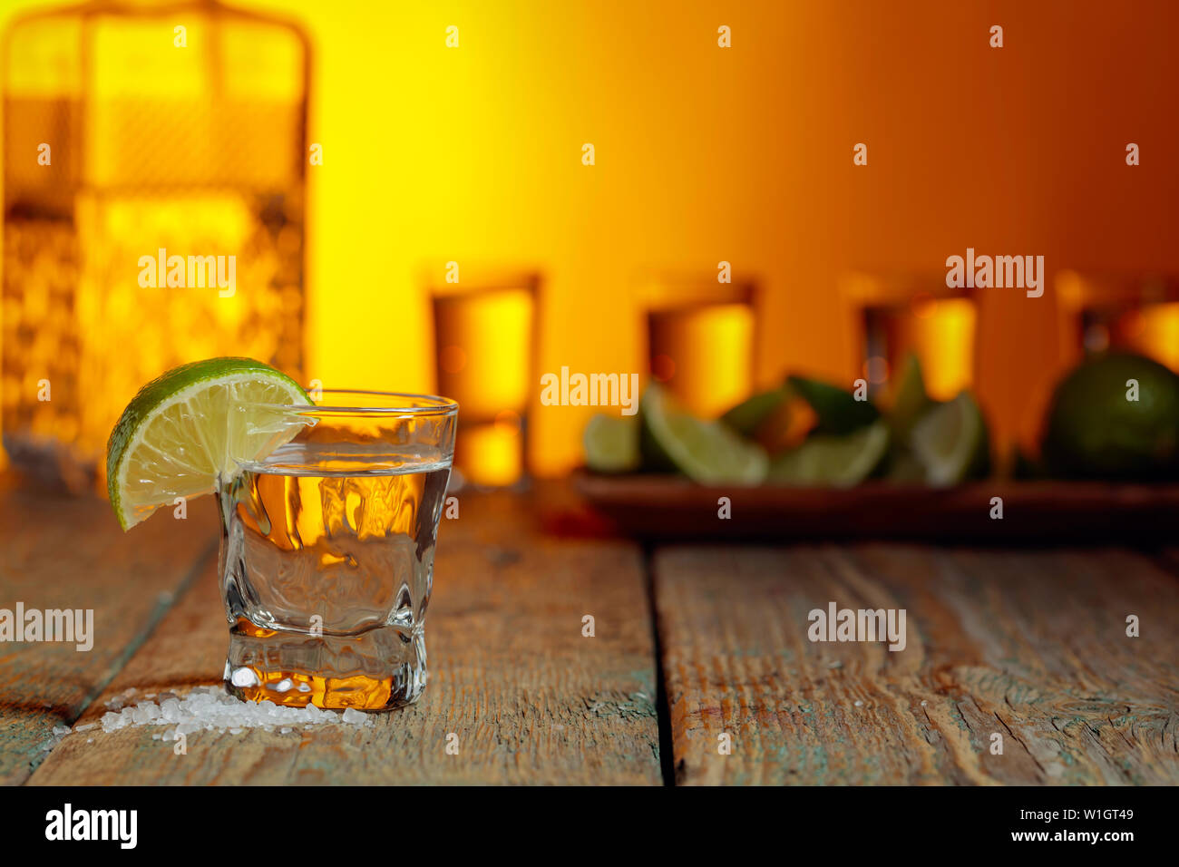 Tequila with sea salt and lime on a old wooden background. Copy space ...