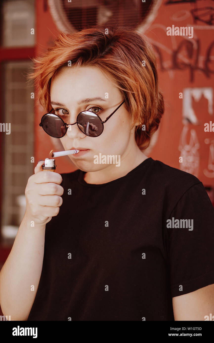 Millennial cool pretty girl with short red hair and mirror sunglasses ...