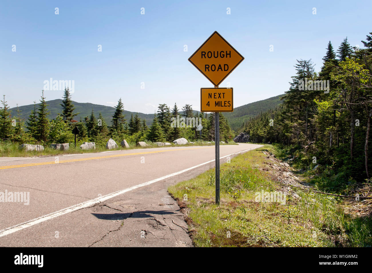An American yellow road sign warning drivers that the road is rough for ...