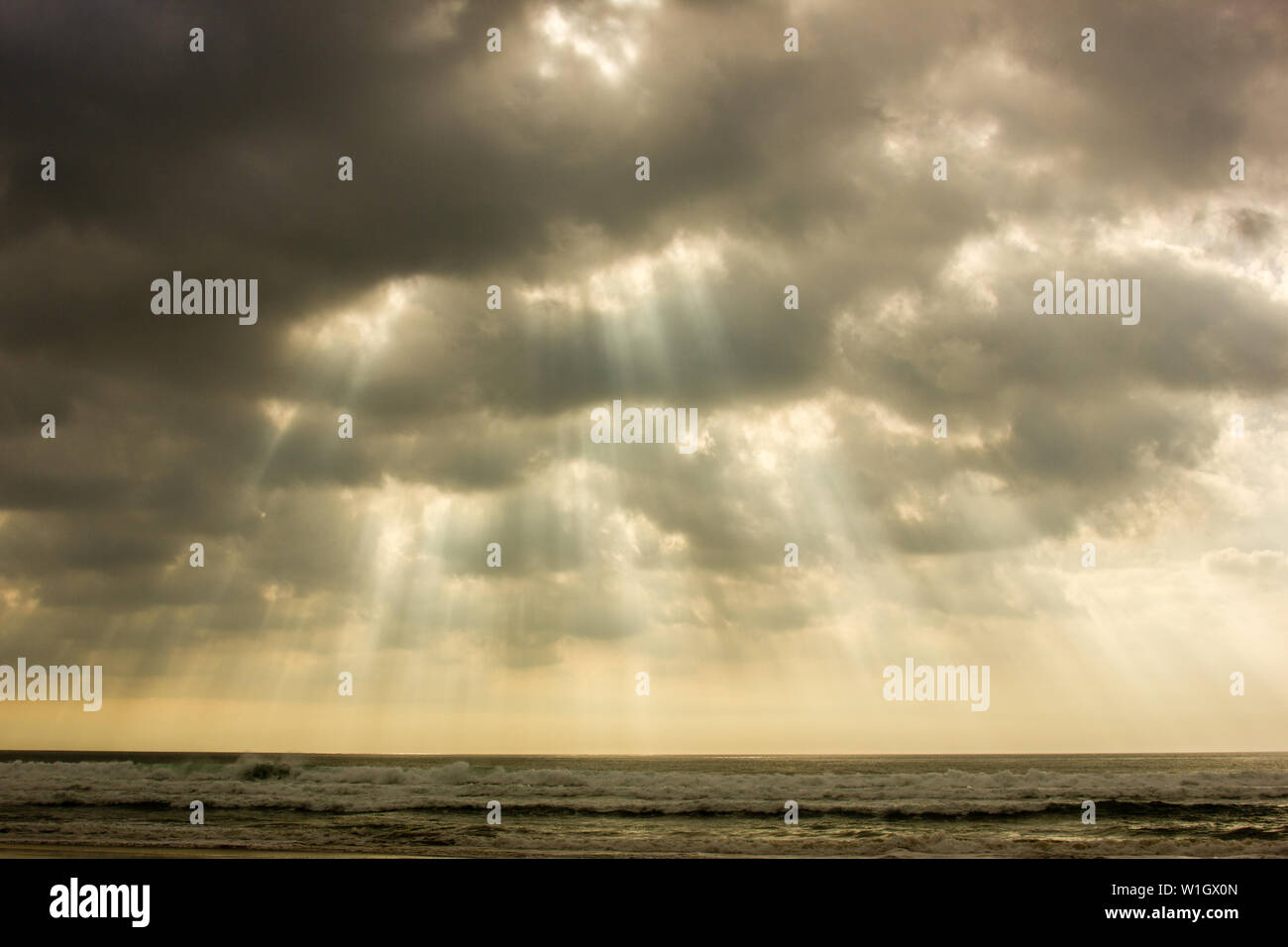 sunset beach rain sea storm Stock Photo - Alamy