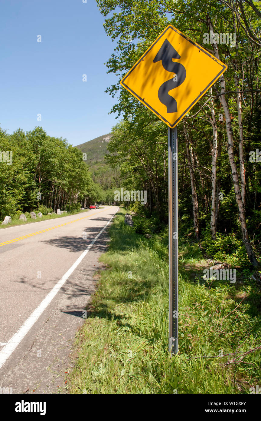 Twisting road sign on an American road Stock Photo - Alamy