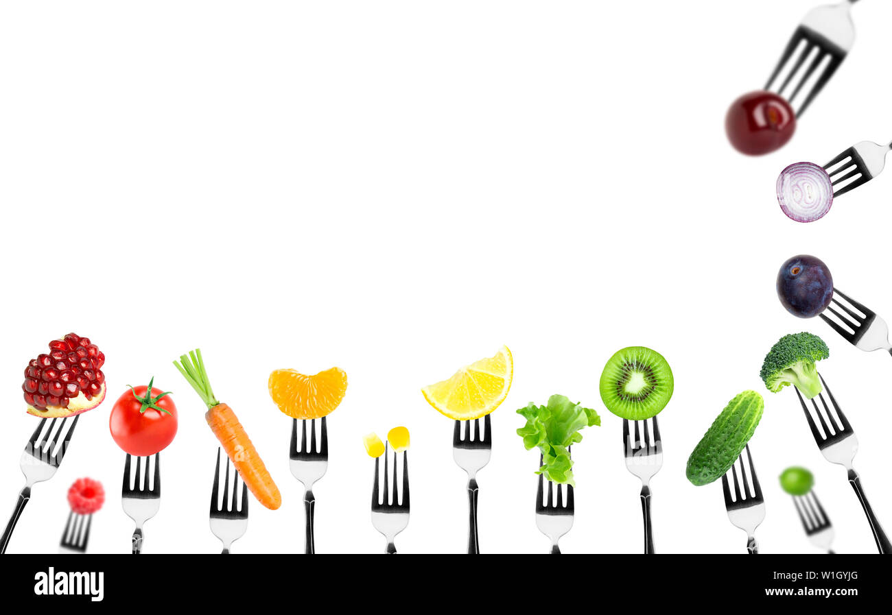 Fruits and vegetables on the forks. Healthy food Stock Photo - Alamy