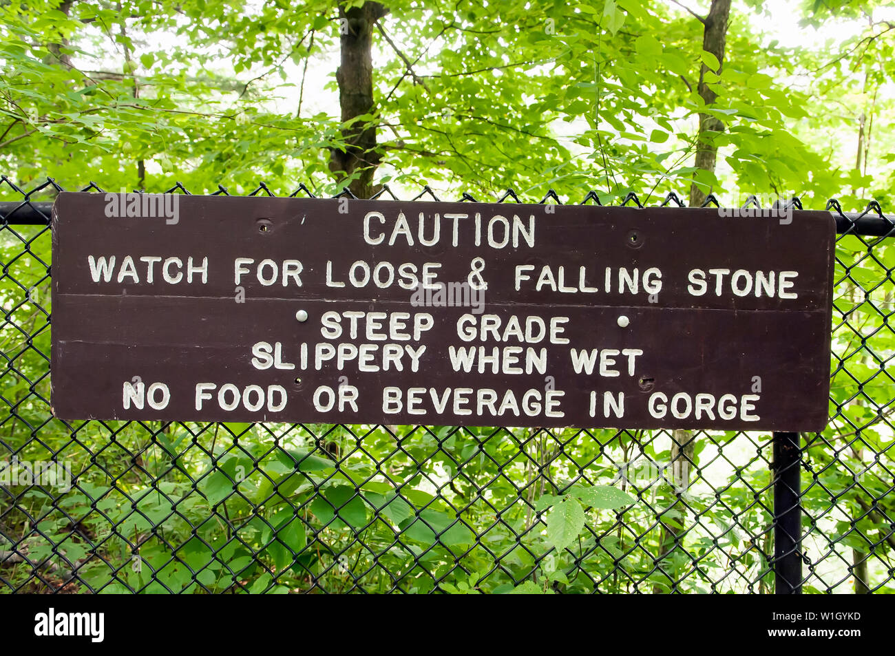 A wooden sign with various instructions of how to behave in an American ...