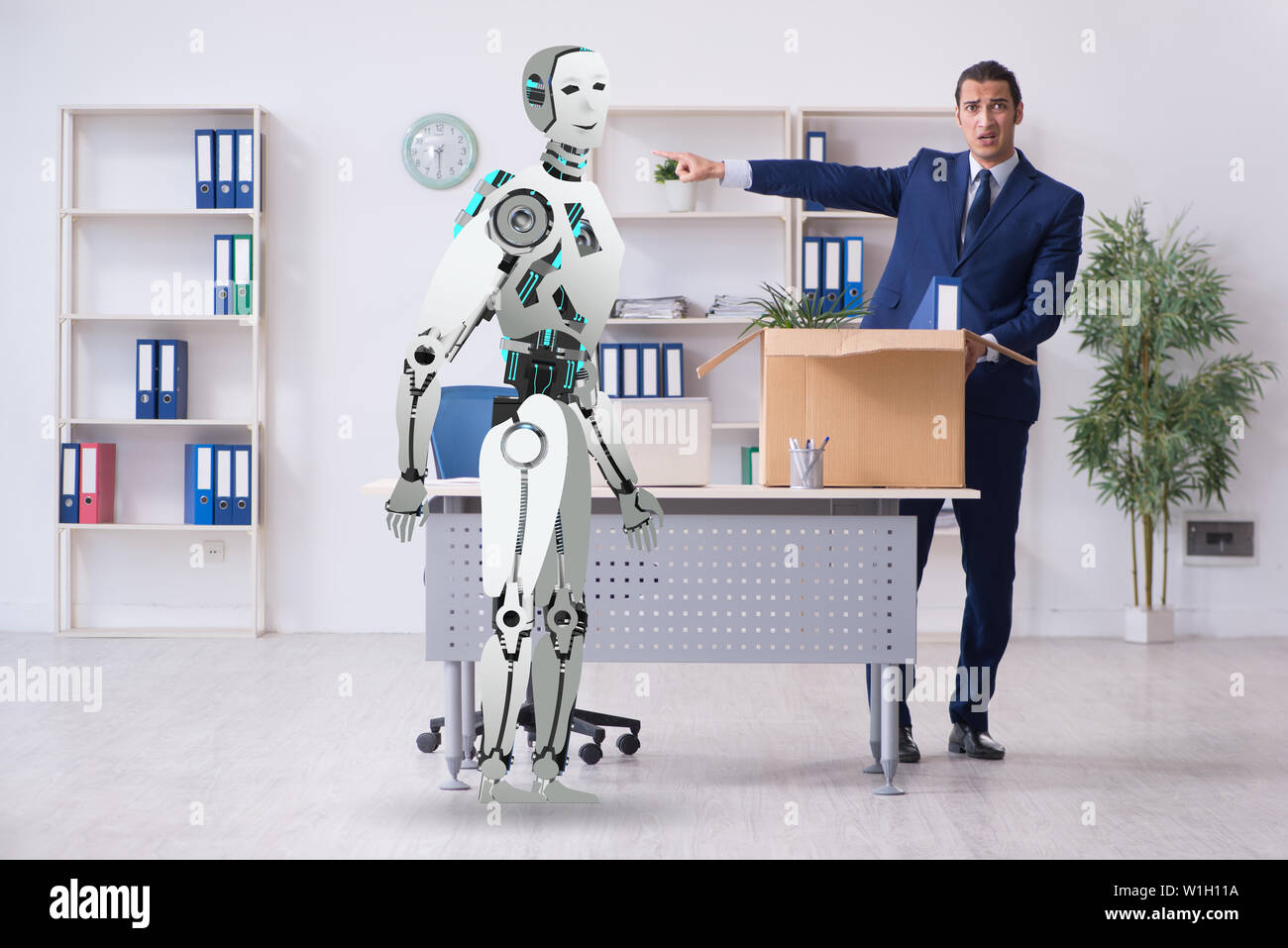 Concept of robots replacing humans in offices Stock Photo - Alamy