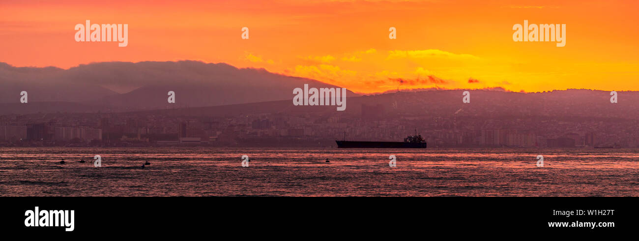 Bright red sunset sky over city and mountains. Fine landscape Stock ...
