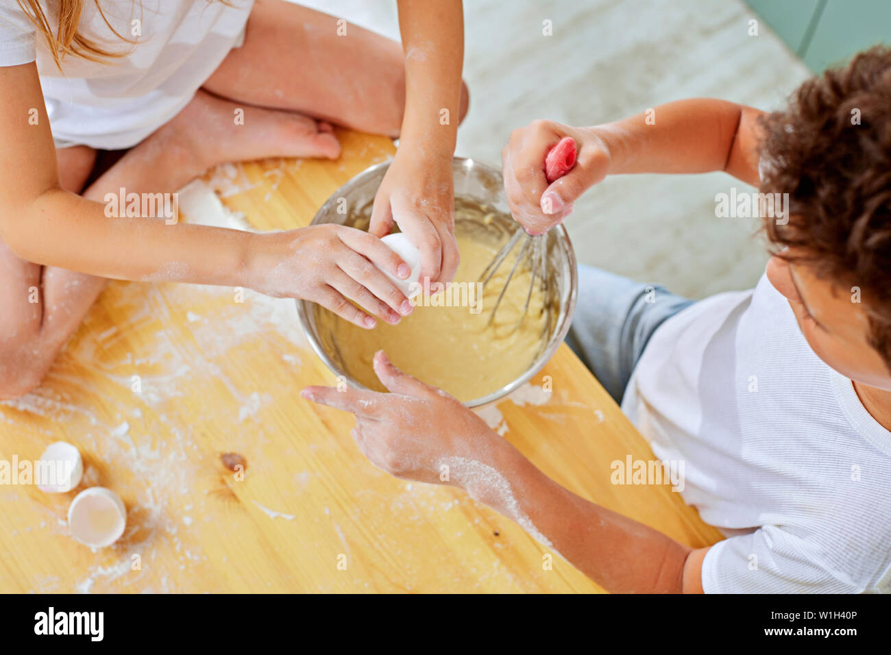 Happy children cooking homemade pastry in kitchen Stock Photo - Alamy