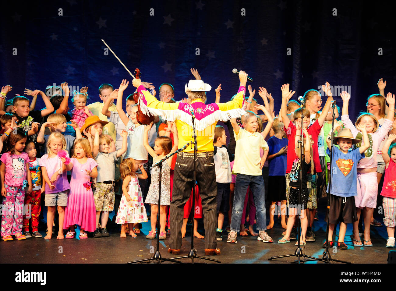 Hall of Fame fiddler Woody Paul leads the kids on stage as legendary ...