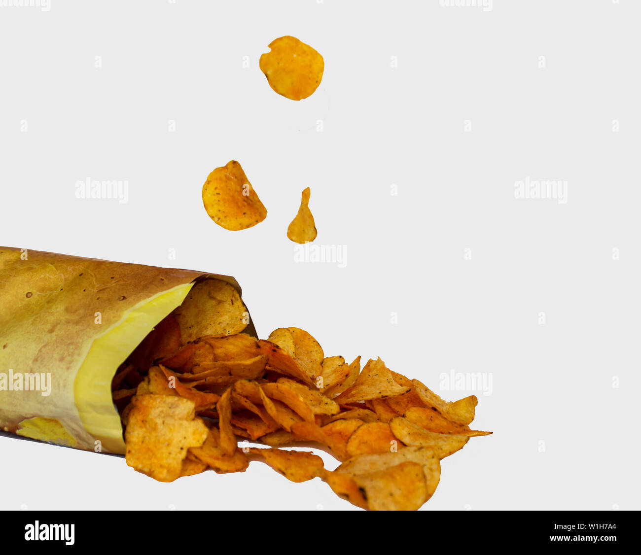 A pile of potato chips. Chips fall out of the pack. chips isolate fried ...