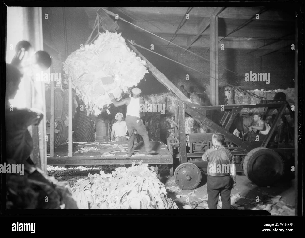 New York, New York - Longshoremen. Large bale being lifted by crane and ...