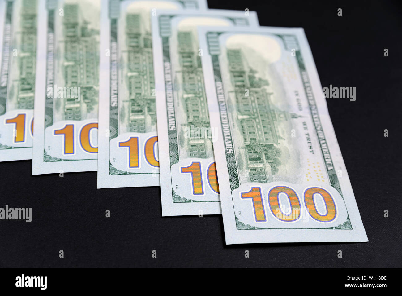 Banknotes 100 US dollars are on a black background Stock Photo - Alamy