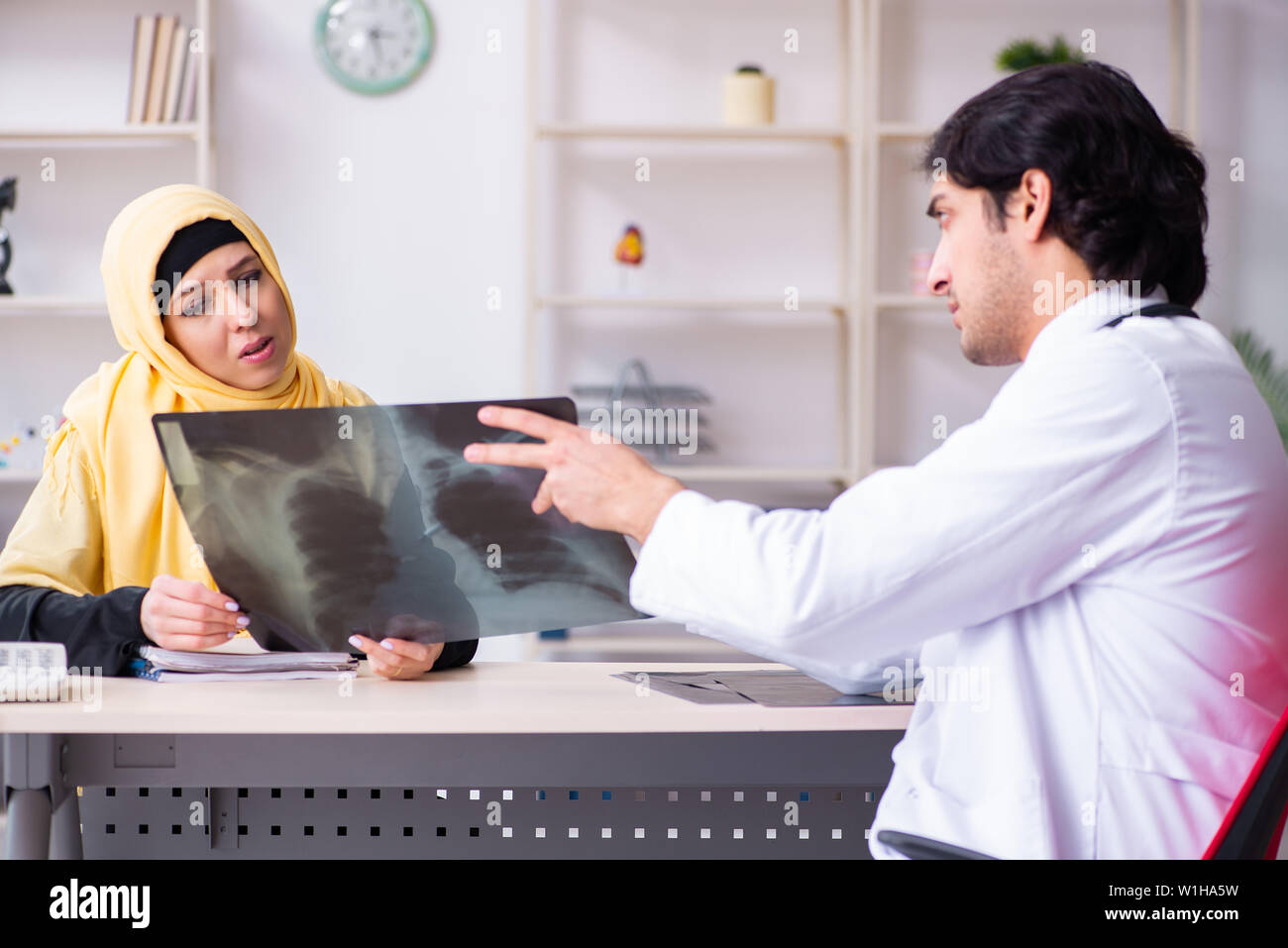 Female arab patient visiting male doctor Stock Photo - Alamy