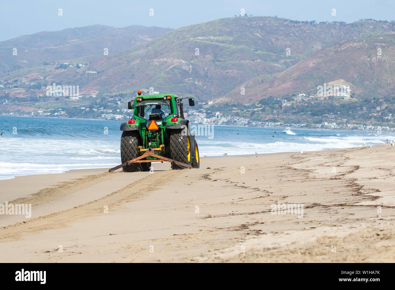 Beach cleaning tractor on Zuma Beach California USA Stock Photo - Alamy