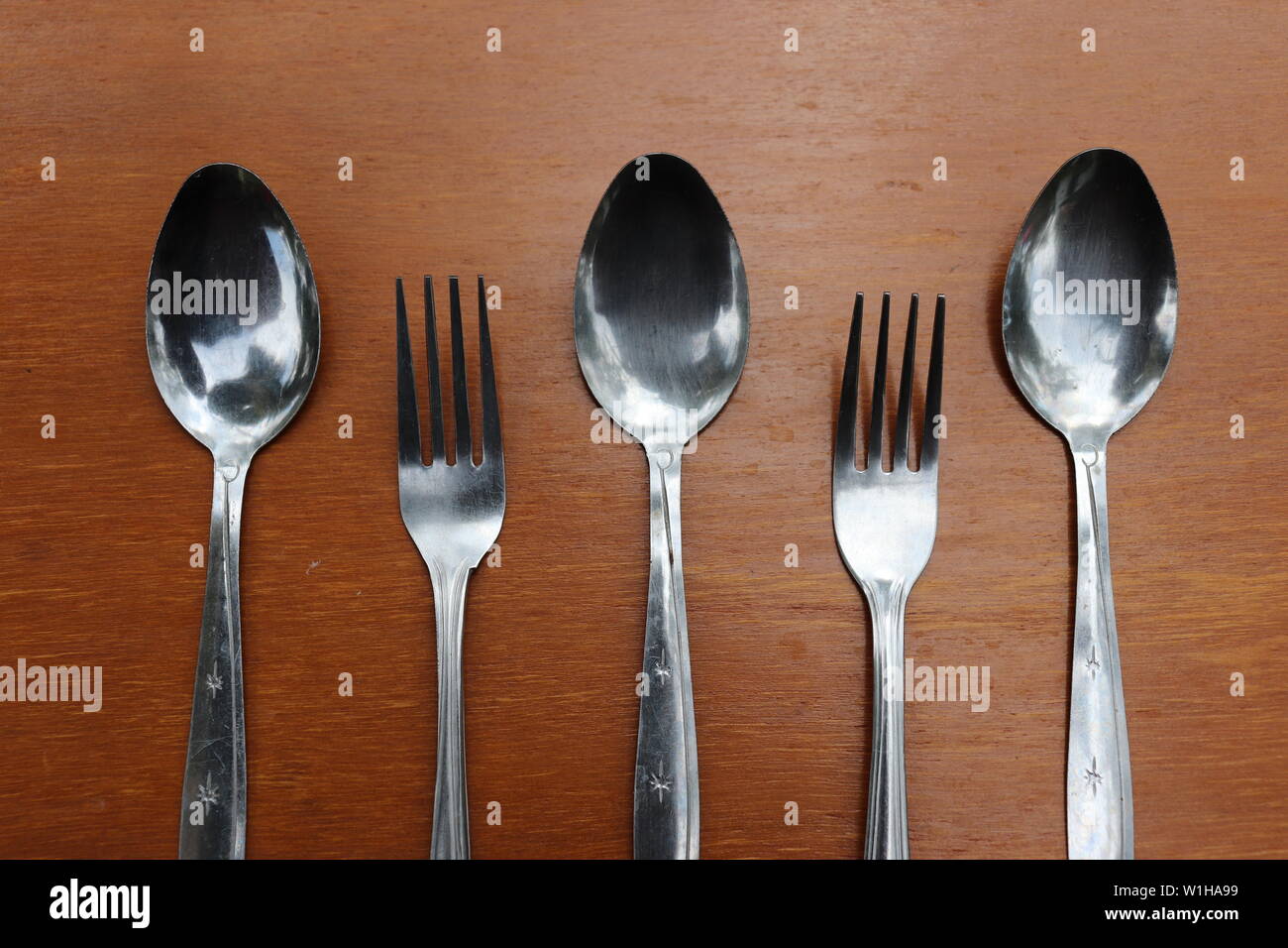 tableware with a brown wood table background Stock Photo - Alamy