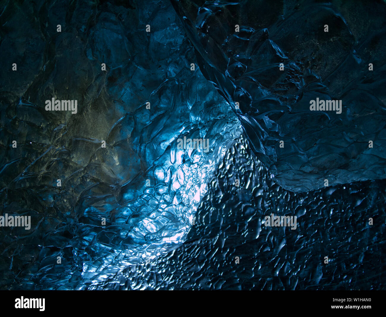 The light-flooded blue ice from a glacier cave in Iceland Stock Photo ...