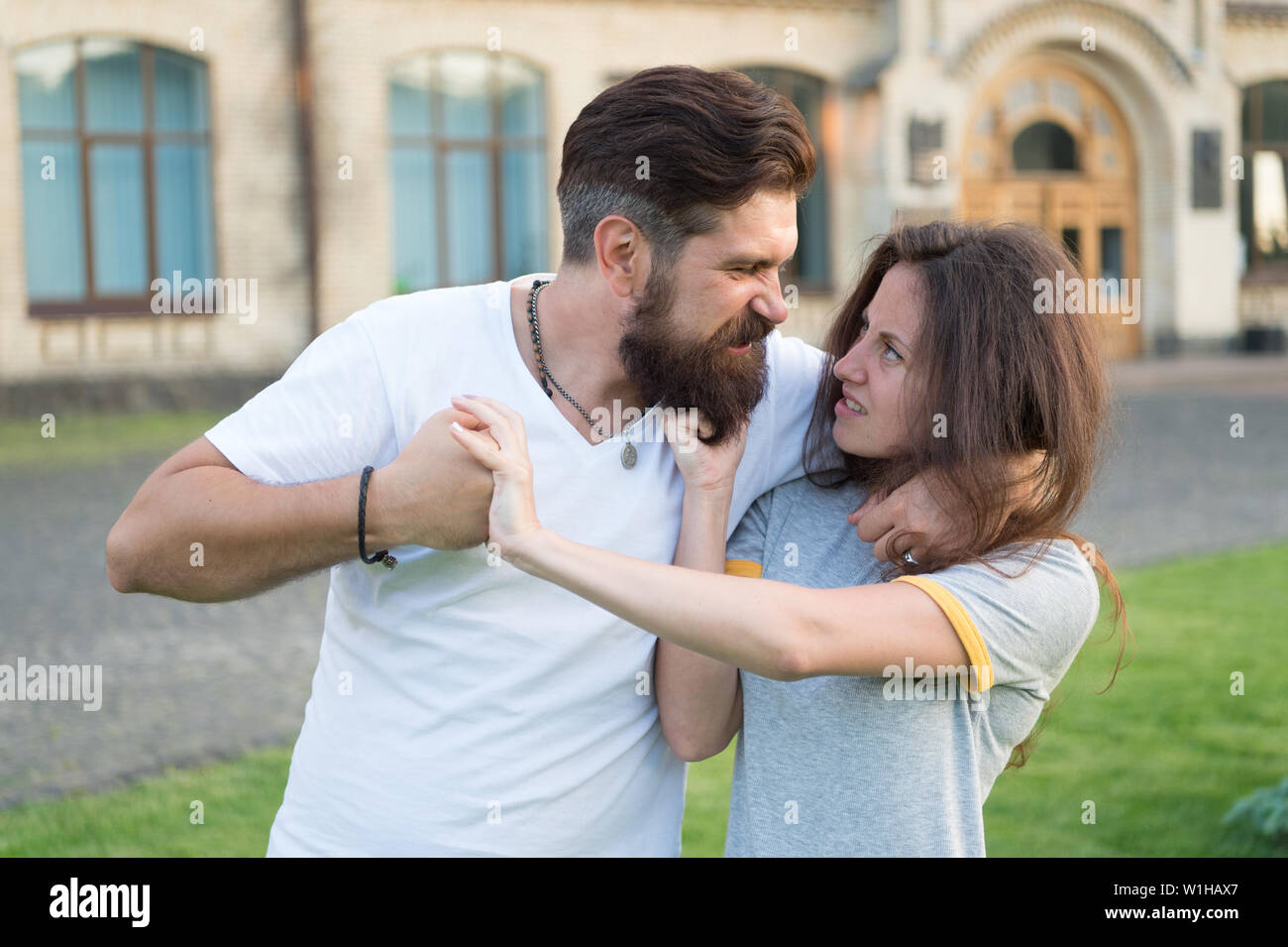 Stop it. Brutal hipster fighting with pretty woman. Violence concept ...