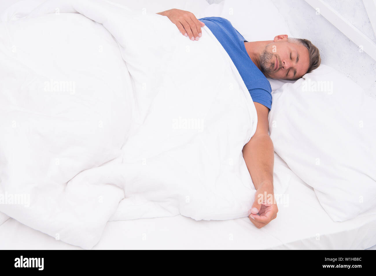 Healthy habits. Man handsome guy lay in bed sleeping. Get enough amount ...