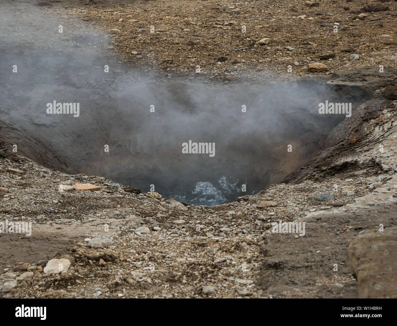 Water vapour over a small geothermal spring in Iceland Stock Photo - Alamy