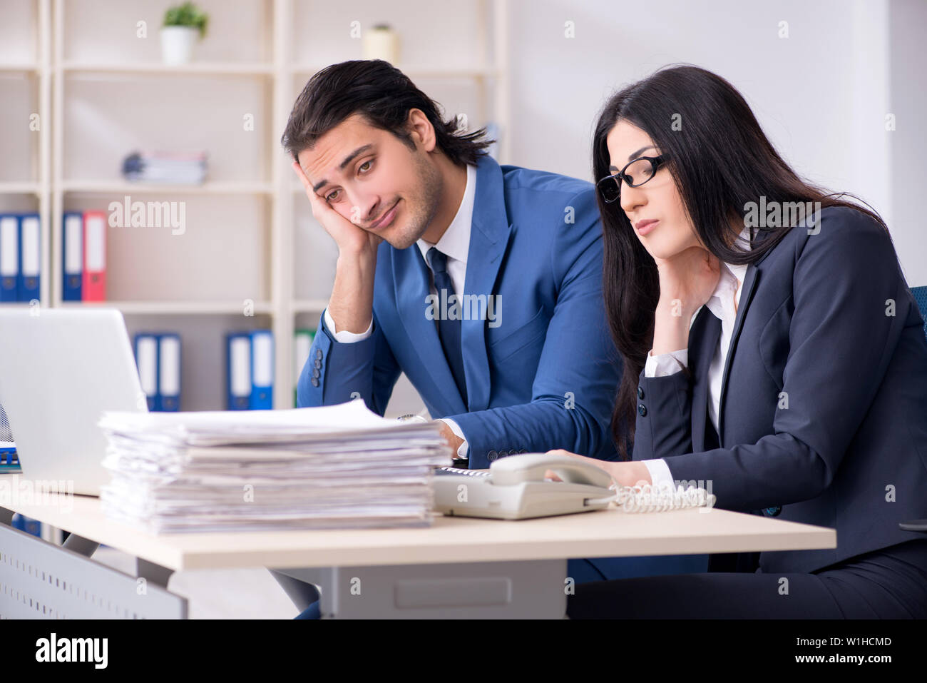 Two employees working in the office Stock Photo - Alamy