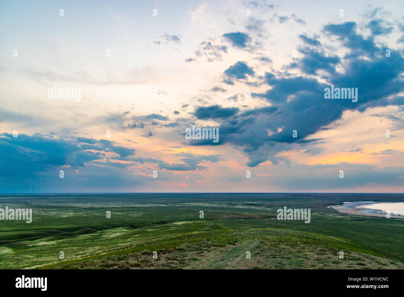 Scenic sunset with clouds in sky in steppe Stock Photo - Alamy
