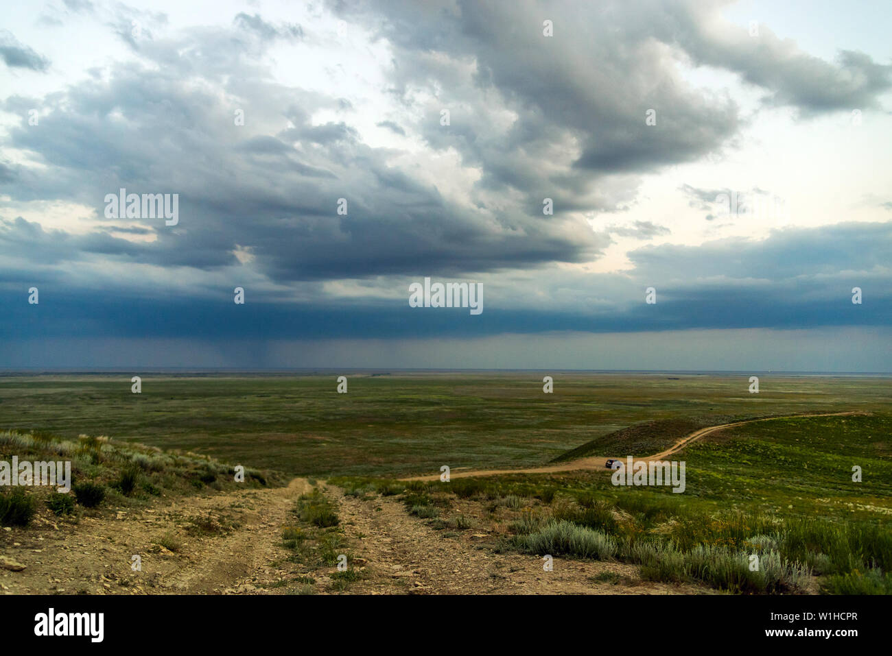 Scenic sunset with clouds in sky in steppe Stock Photo - Alamy