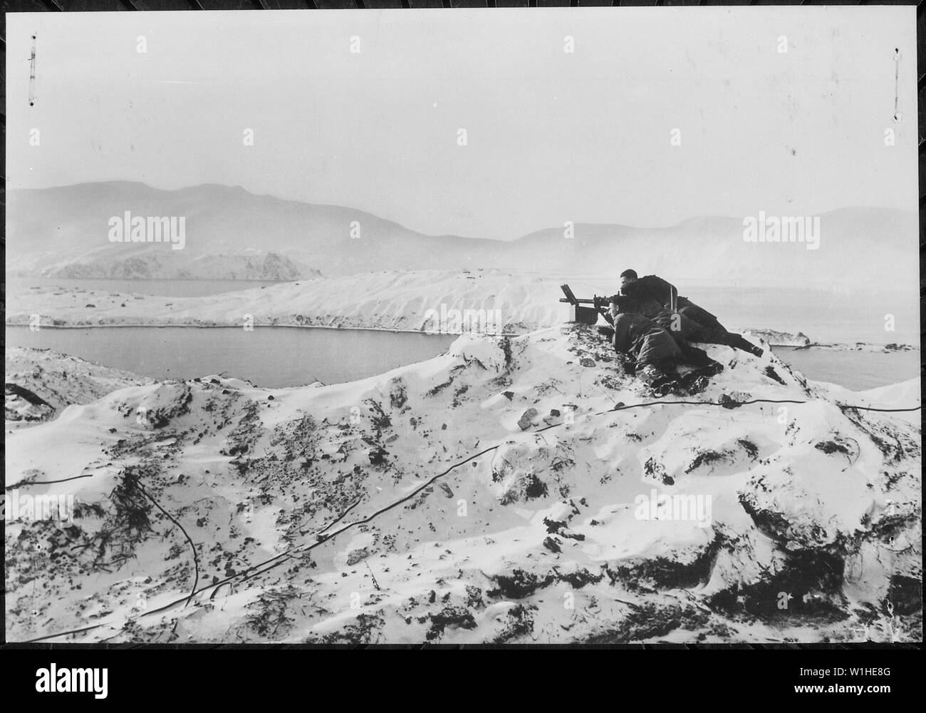 On high ground overlooking an icy inlet in Alaska, U.S. Marines man a ...