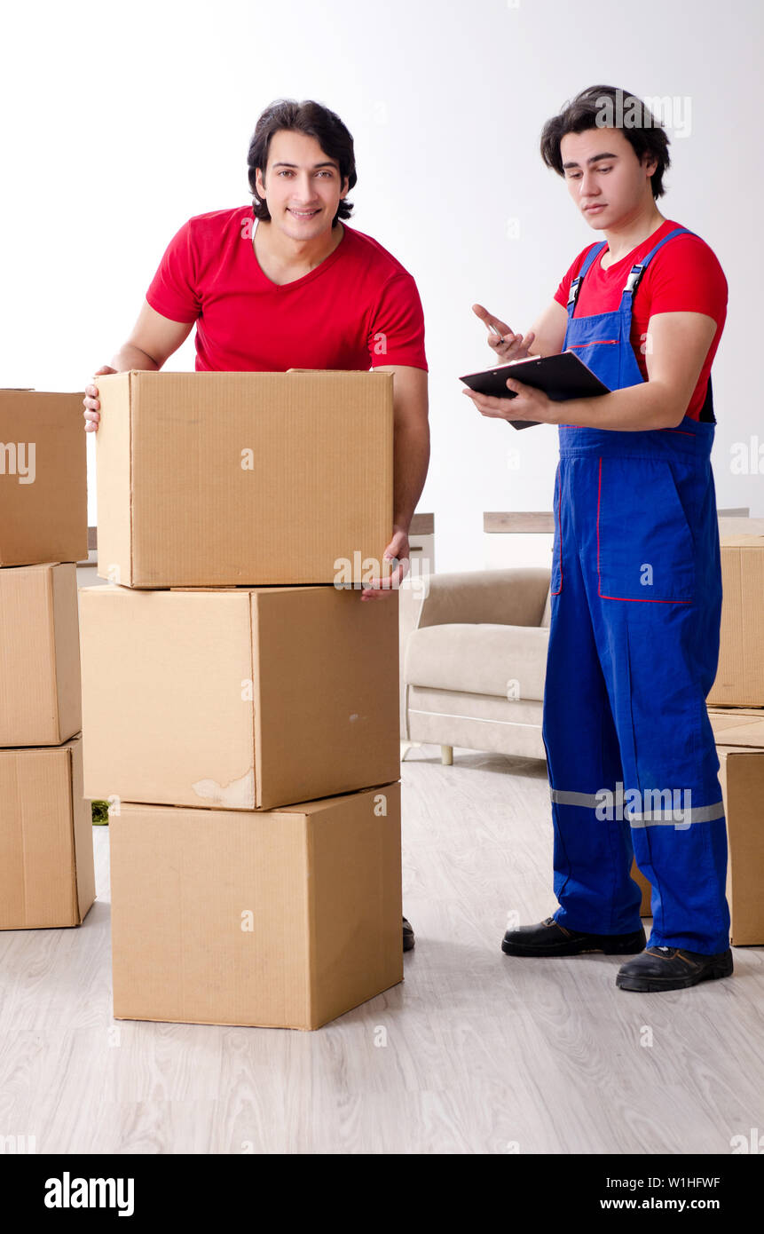 Two young contractor employees moving personal belongings Stock Photo ...