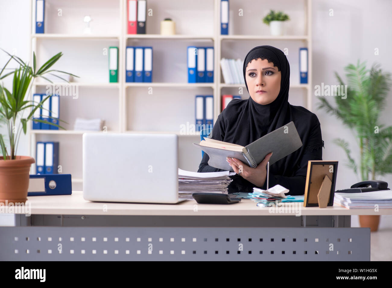 Female employee bookkeeper in hijab working in the office Stock Photo ...