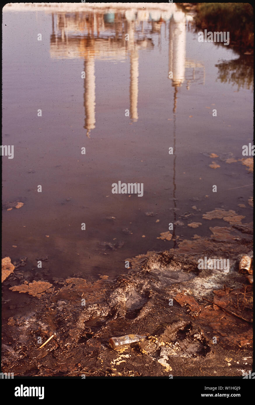 PETROLEUM INSTALLATION RELECTED IN POLLUTED POND Stock Photo - Alamy